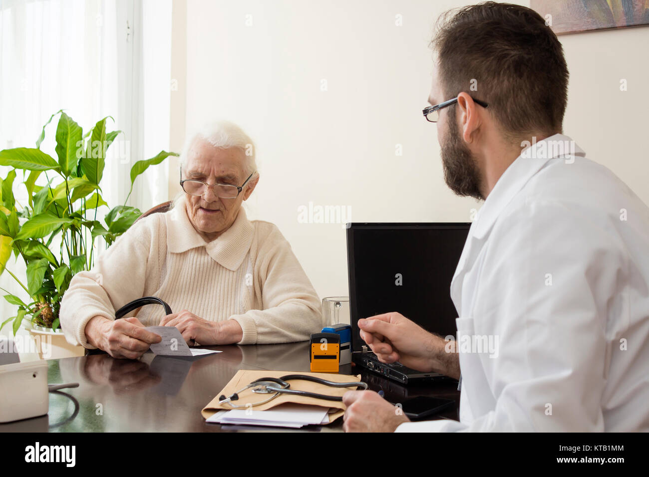 geriatrician doctor with a patient in his office.old woman at the ...