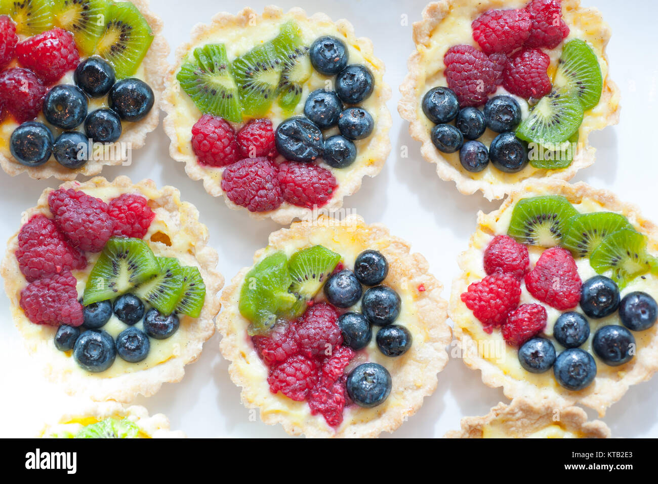 Raspberry blueberry strawberry and kiwi fruit tarts Stock Photo - Alamy