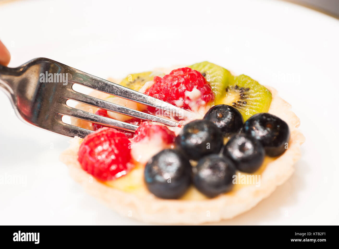 Raspberry blueberry strawberry and kiwi fruit tarts Stock Photo - Alamy