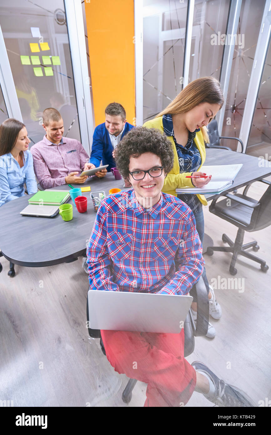 Portrait of startup group of creative people having a meeting with a ...