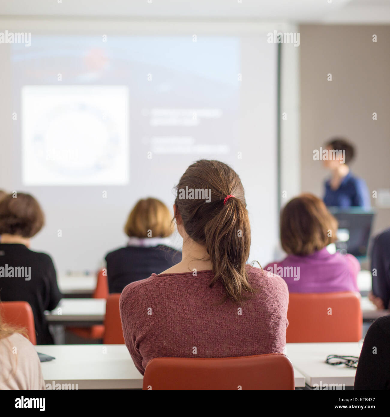 Woman giving presentation in lecture hall at university Stock Photo - Alamy