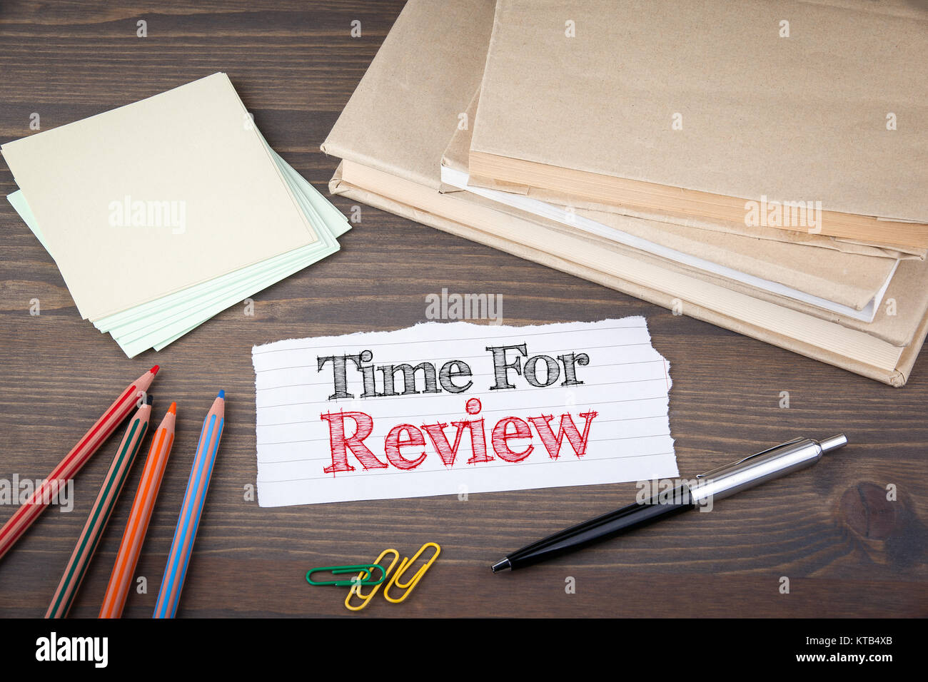 Time for review. Paper sheet from the booklet on the wooden table Stock ...