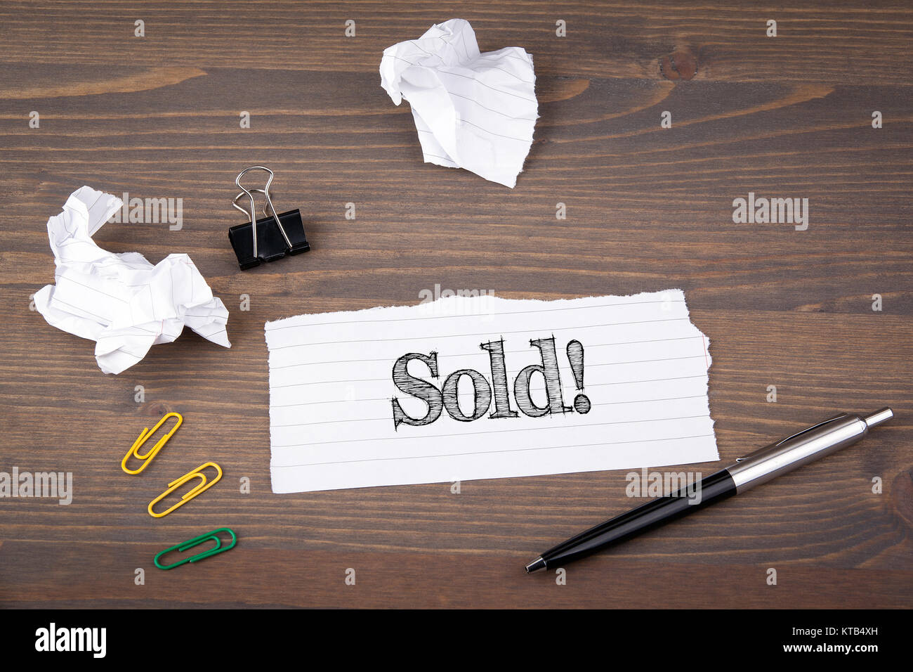 Sold. paper sheet from the booklet on the wooden table Stock Photo - Alamy