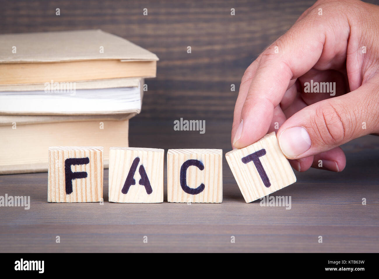 fact. Wooden letters on dark background. Office desk Stock Photo - Alamy
