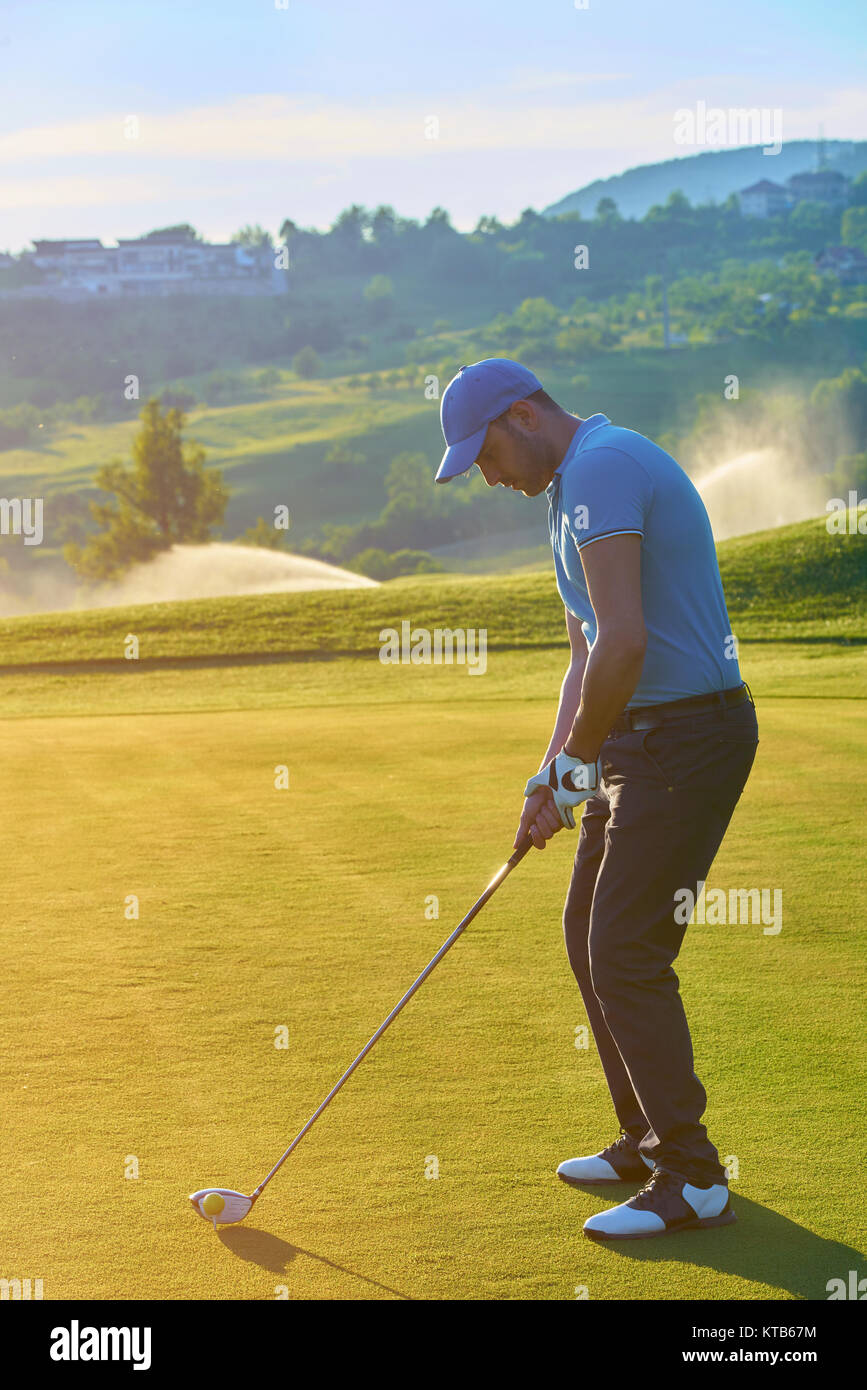 Young person playing golf on a sunny day Stock Photo - Alamy