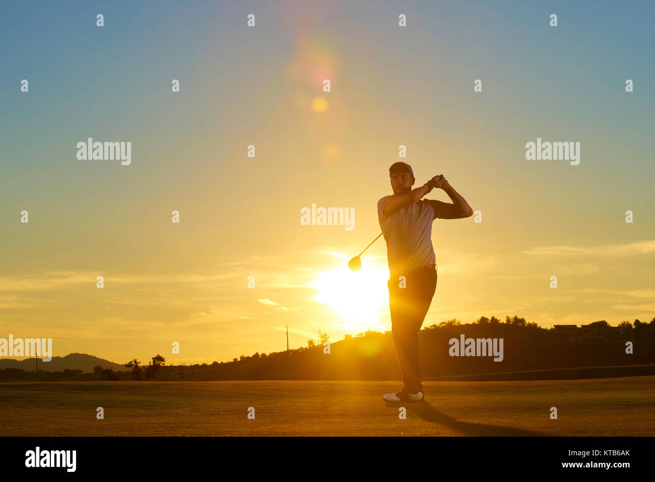 Man playing golf ion the evening Stock Photo - Alamy