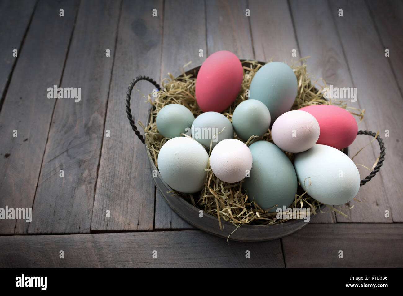 Easter basket with colorful eggs in country house style close up Stock ...