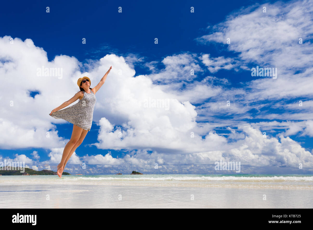 Beautiful woman jumping at the beach Stock Photo - Alamy