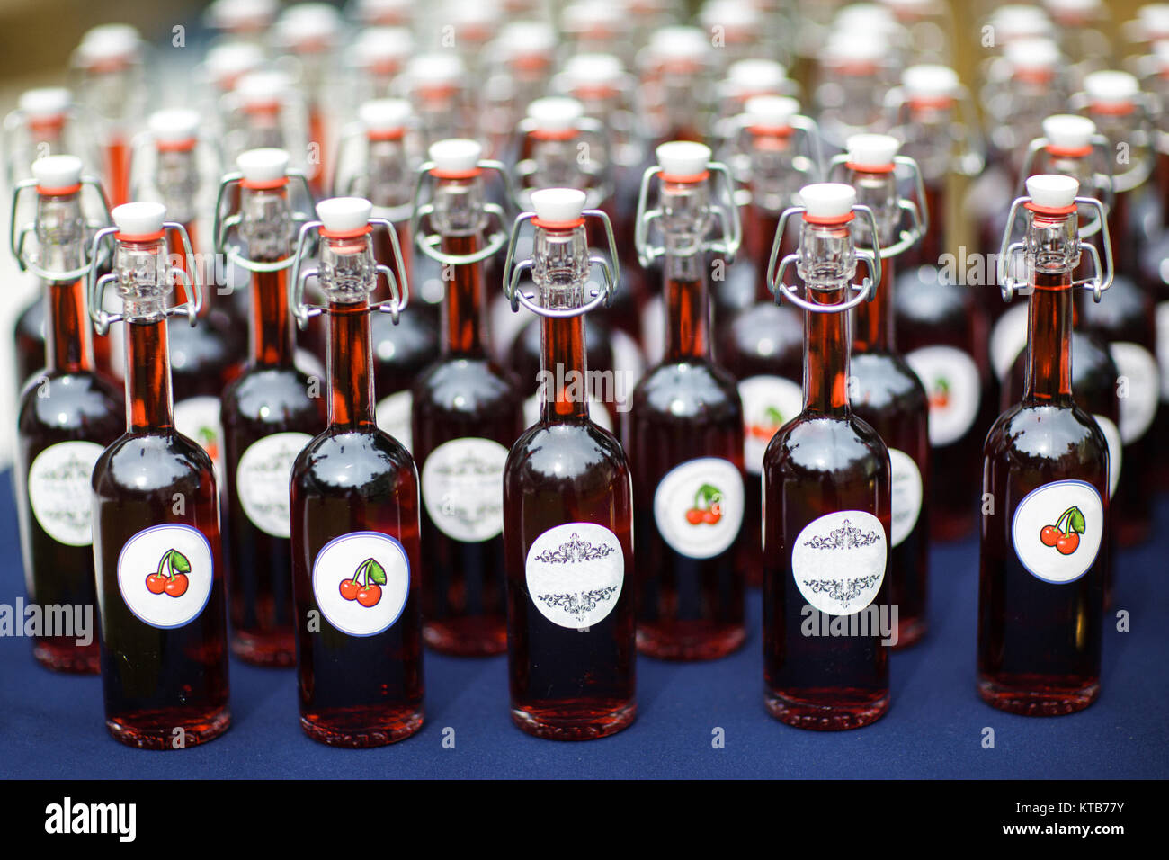 Identical bottles with a drink on a blue table Stock Photo - Alamy