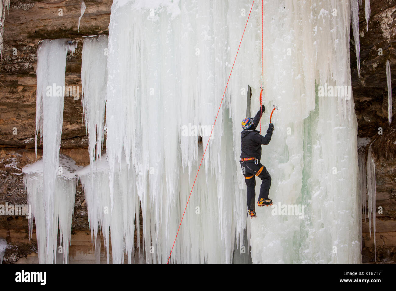 An ice climber in Northern Michigan, climbing at Pictured Rocks ...