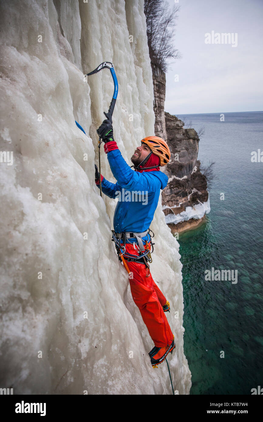 An ice climber in Northern Michigan, climbing at Pictured Rocks ...