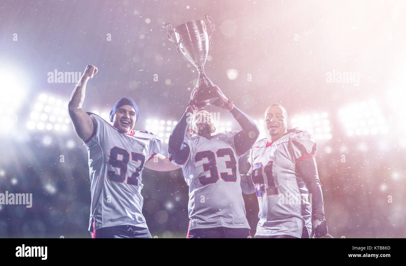 happy american football team with trophy celebrating victory in the cup ...