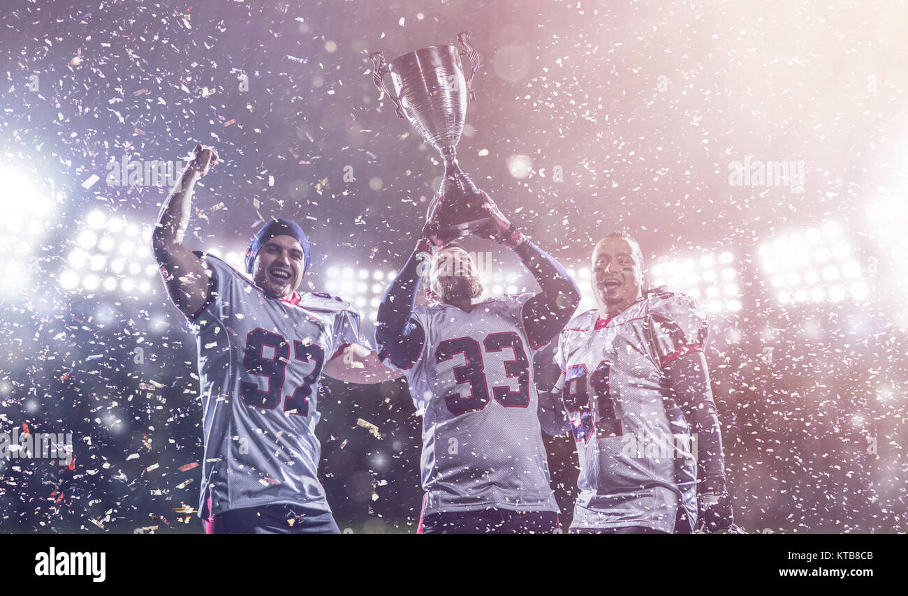 happy american football team with trophy celebrating victory in the cup ...