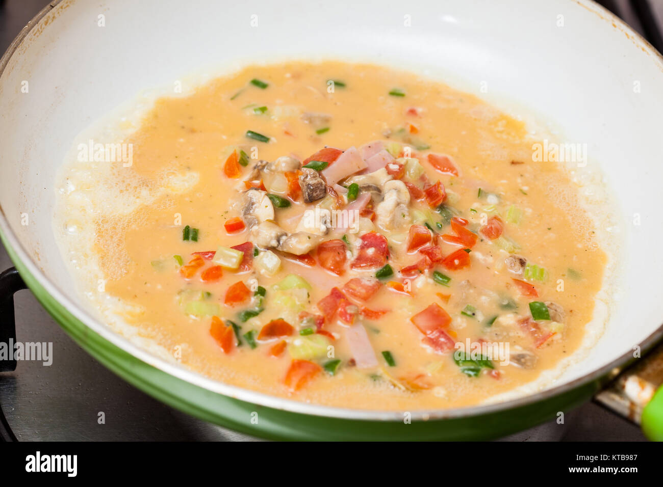 Omelet preparation : Cooking the omelet mix onto a pan Stock Photo - Alamy