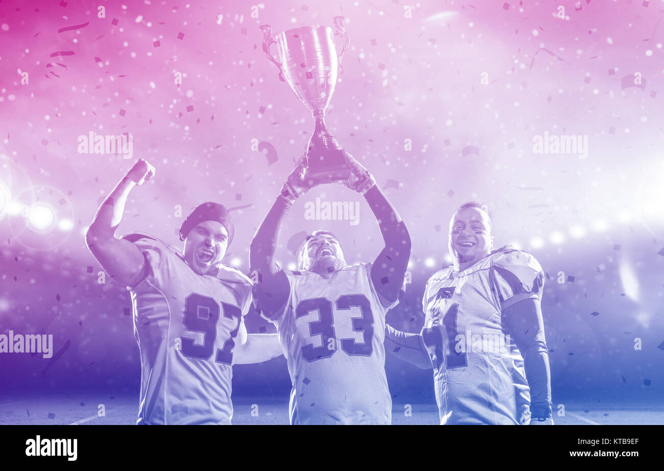 happy american football team with trophy celebrating victory in the cup ...