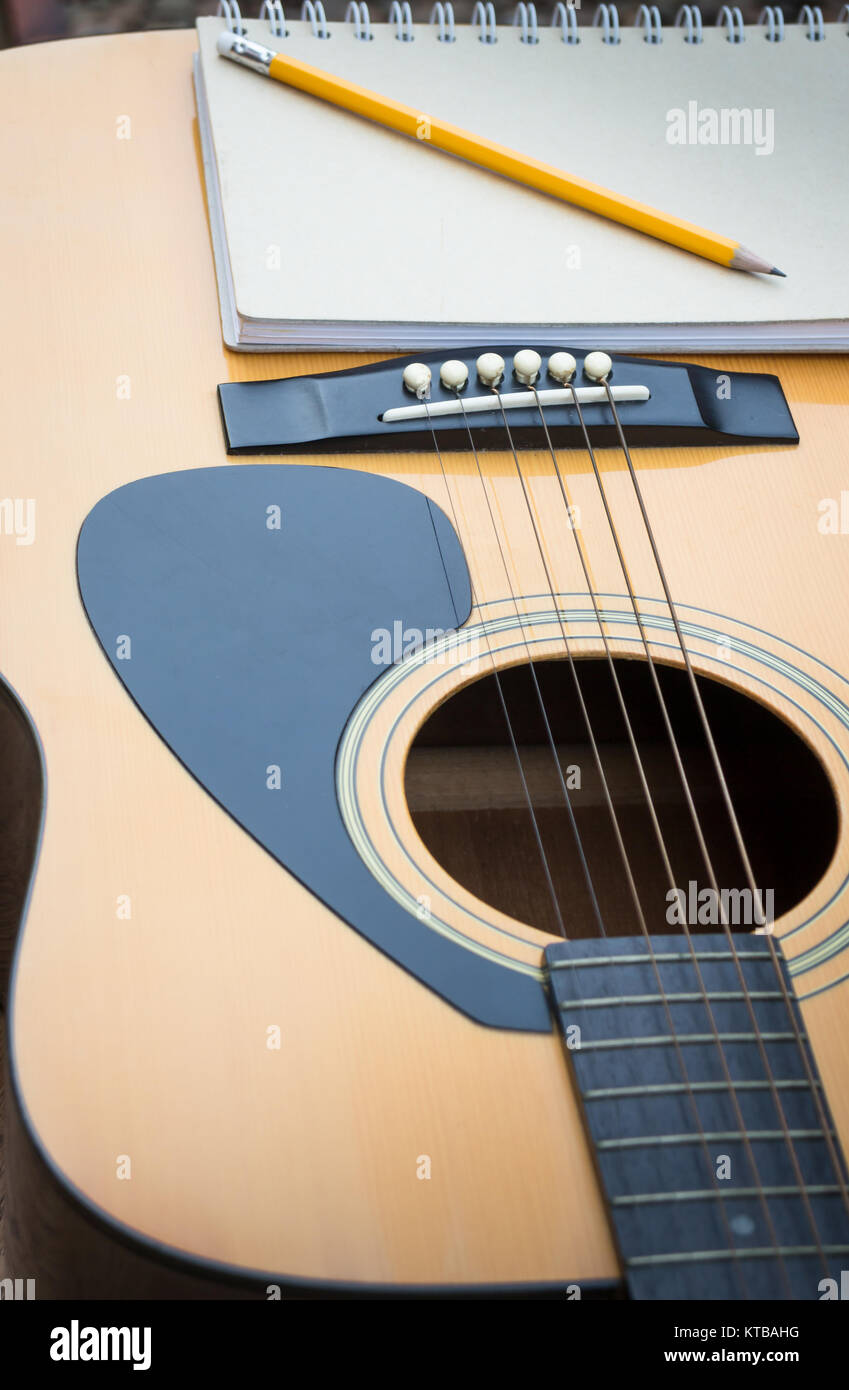 Yellow Acoustic Guitar On Wooden Table Stock Photo - Alamy