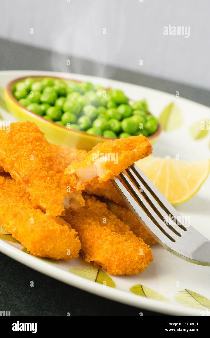 Child eating fish fingers hi-res stock photography and images - Alamy
