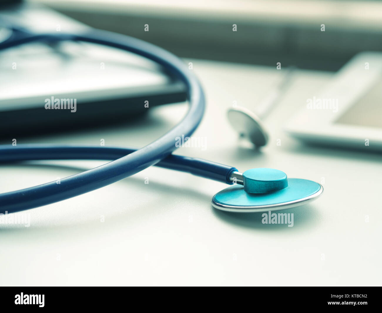 Medical utensils with laptop and tablet computer on a doctor's desk ...