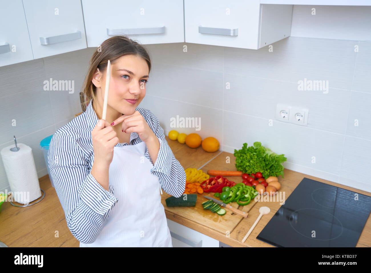Young woman with basket of fresh vegetables in the kitchen Stock Photo ...