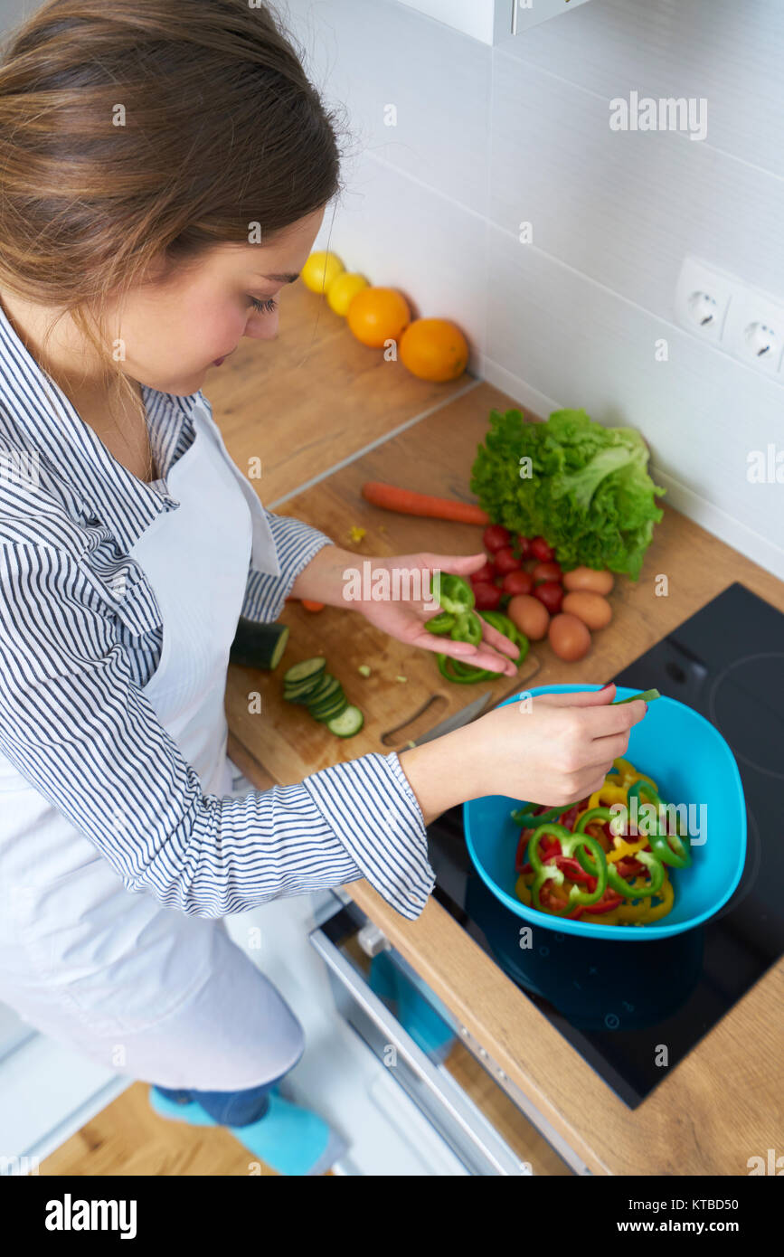 Young woman with basket of fresh vegetables in the kitchen Stock Photo ...