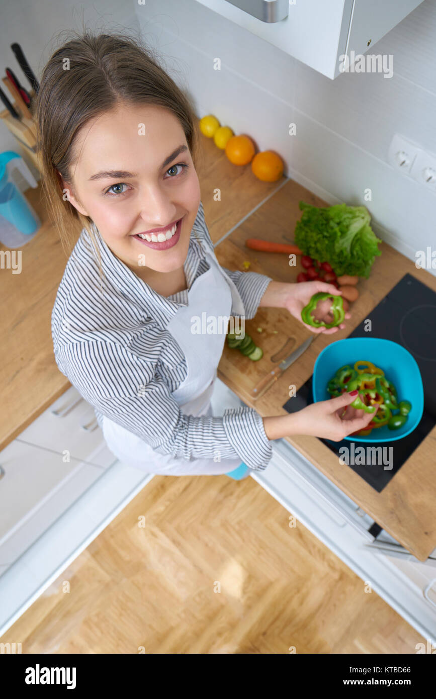Young woman with basket of fresh vegetables in the kitchen Stock Photo ...