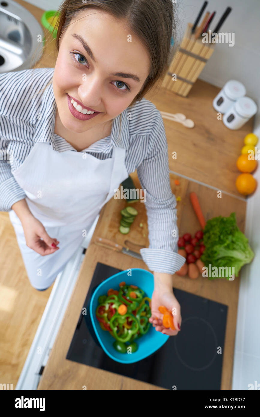 Young woman with basket of fresh vegetables in the kitchen Stock Photo ...