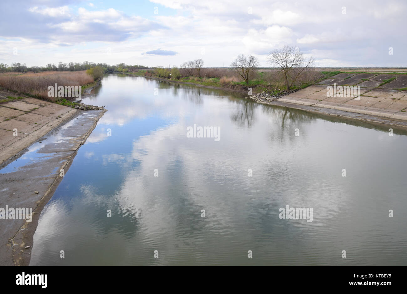 Paved concrete banks of the irrigation canal at the outlet of th Stock ...