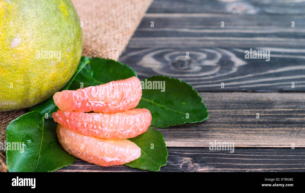 Fresh grapefruit and Grapefruit leaves on black wood Stock Photo - Alamy