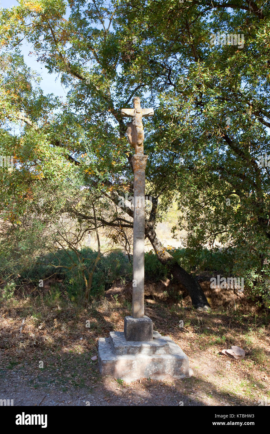 a medieval stone pilgrim cross in the forested mountains of andulcia ...