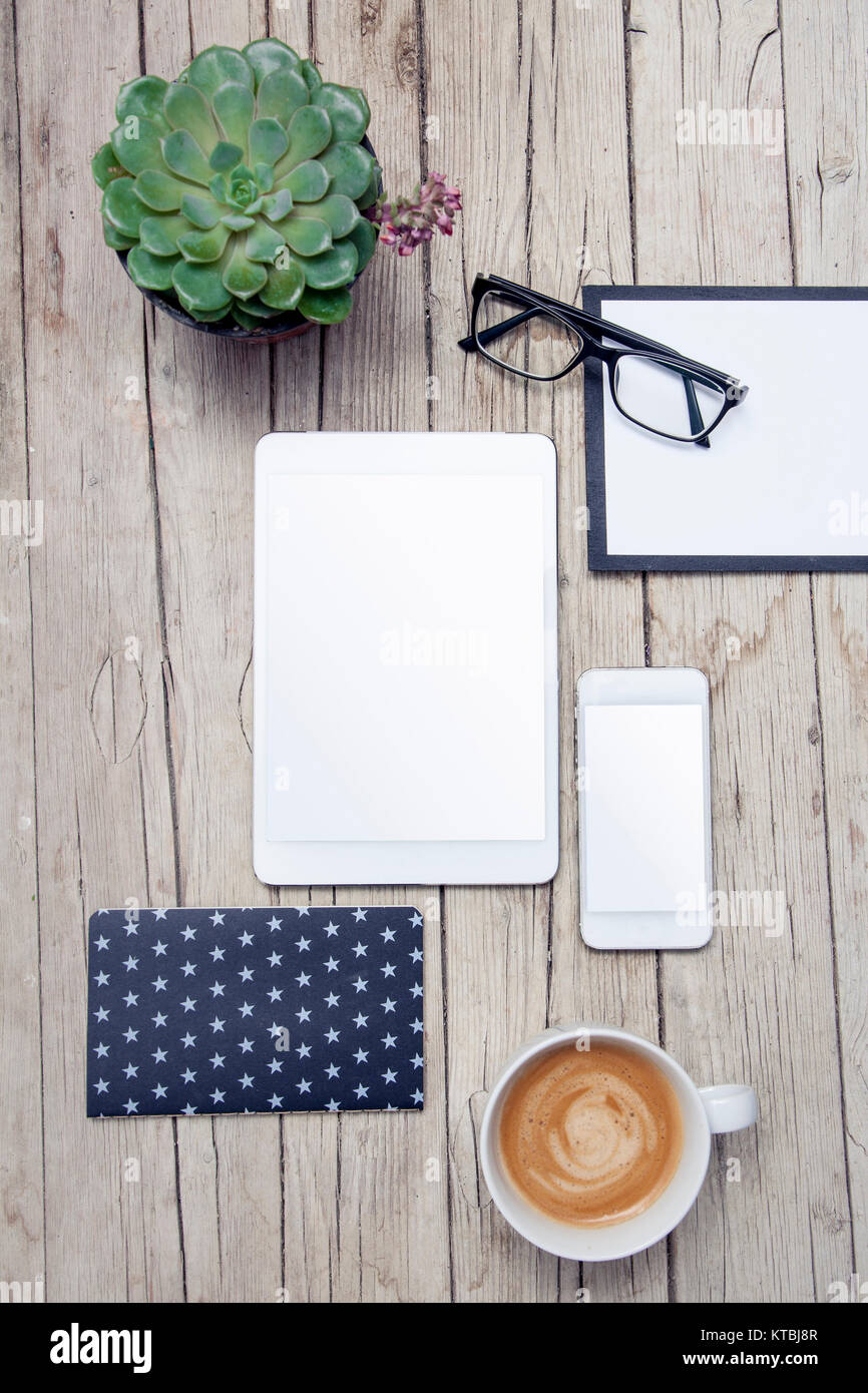 office desk with mock up tablet and handy Stock Photo - Alamy