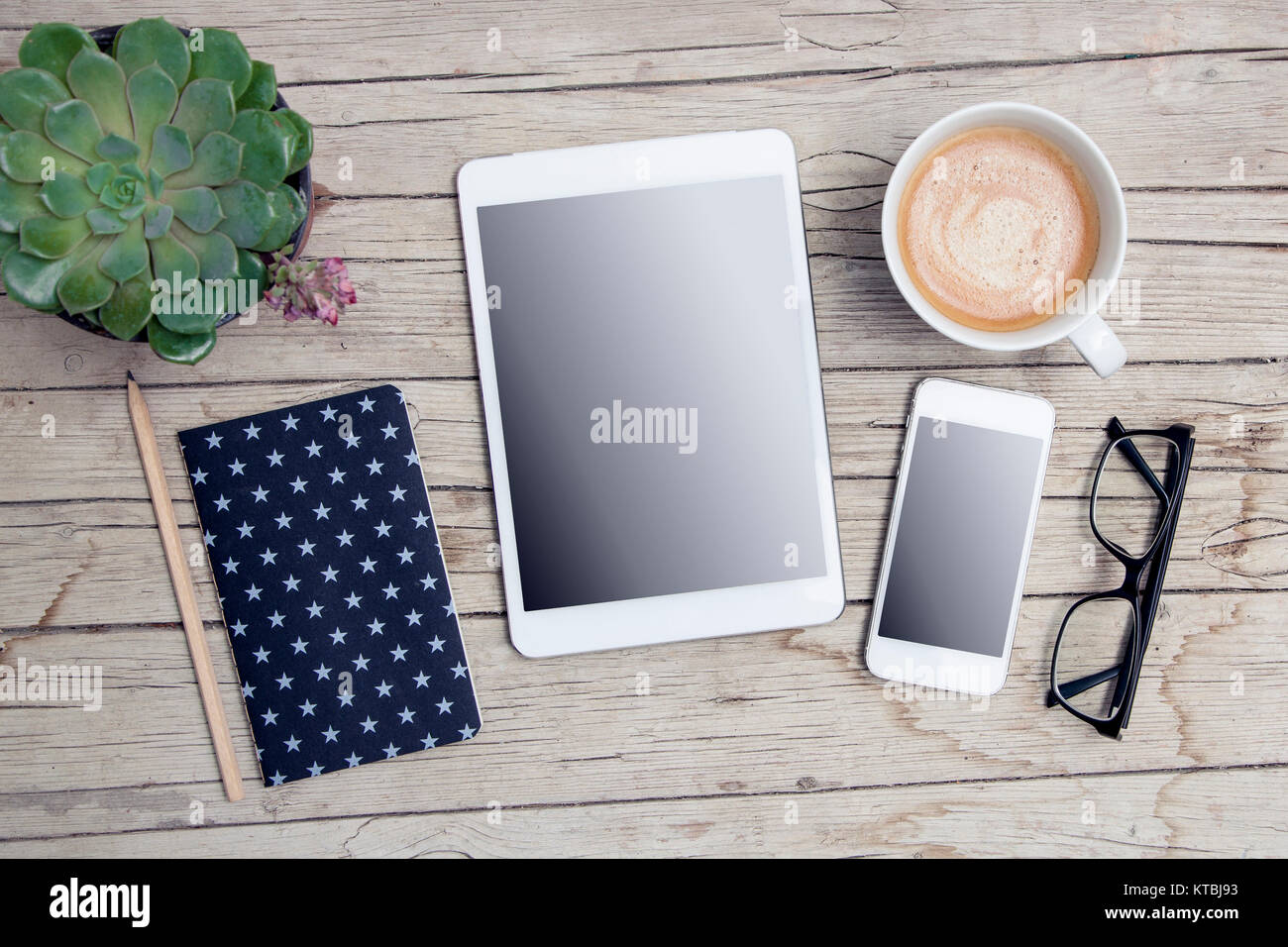 office desk with mock up tablet and handy Stock Photo - Alamy