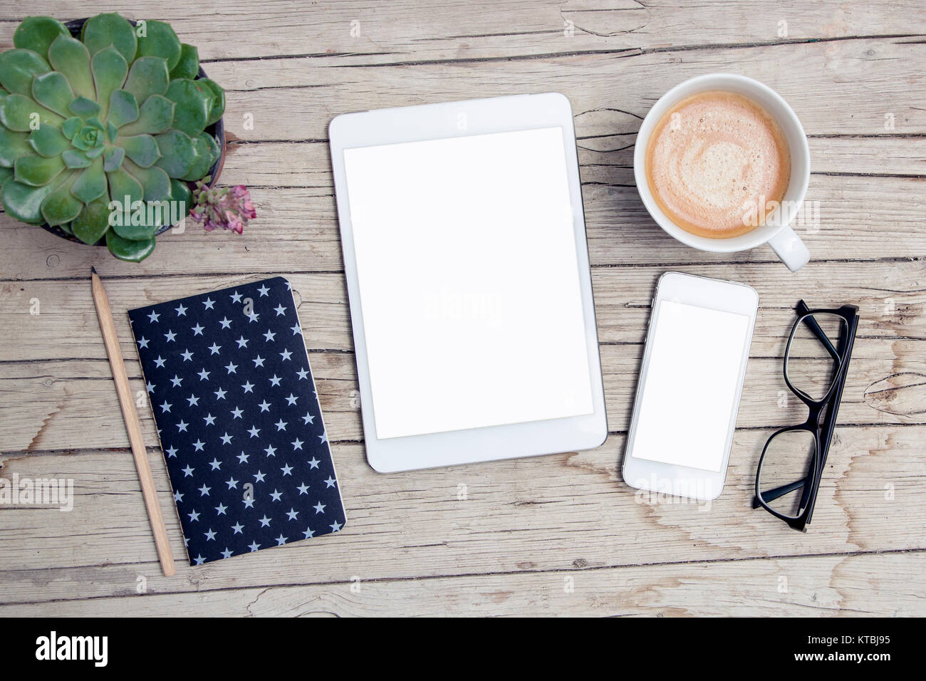 office desk with mock up tablet and handy Stock Photo - Alamy