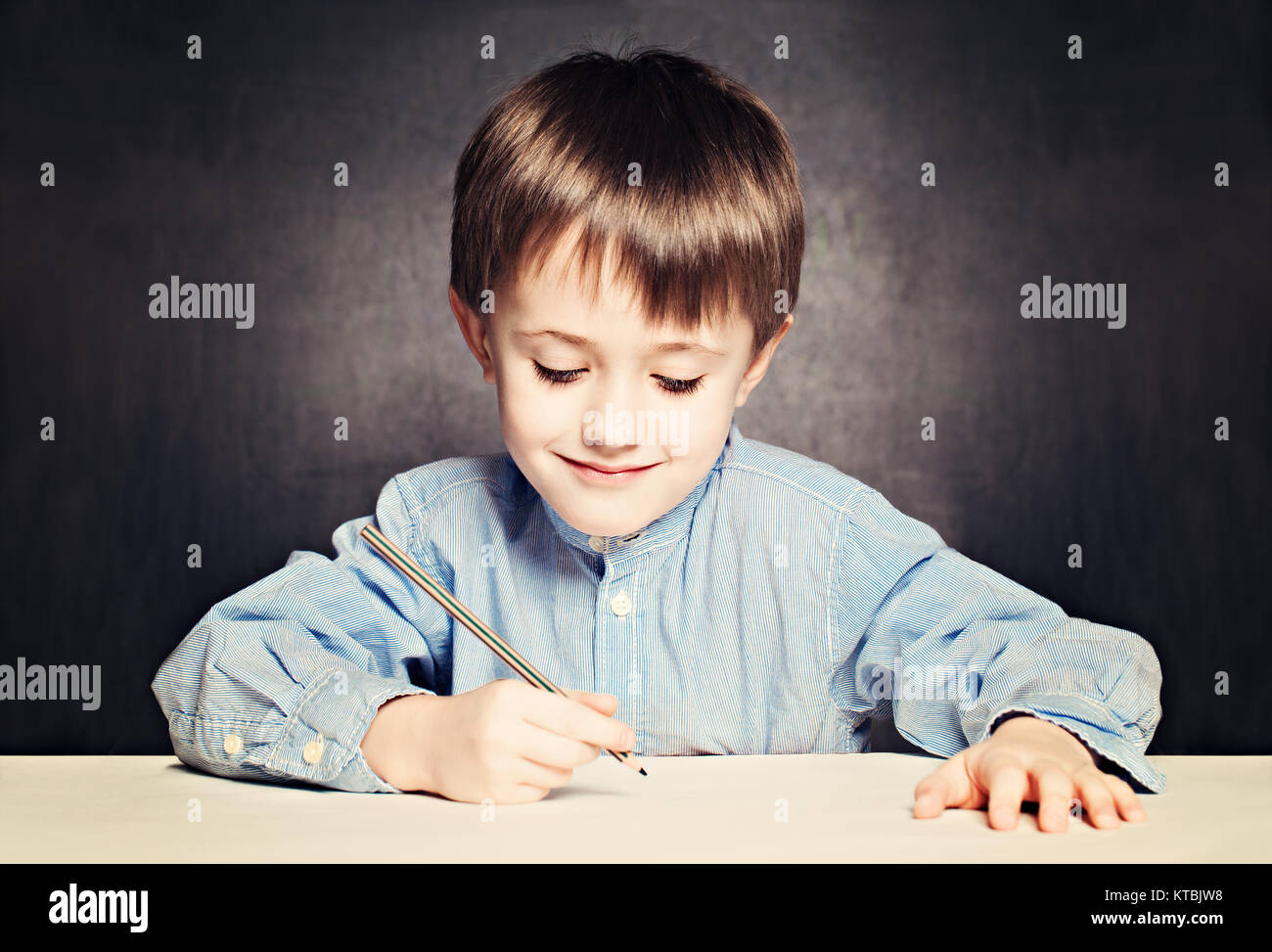 Small Boy Pupil Painting. Child with Pencil Stock Photo - Alamy