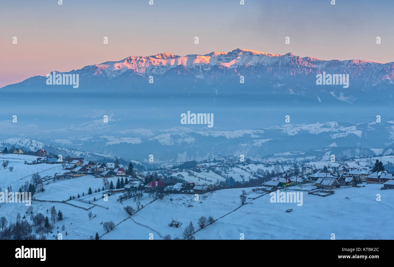Magnificent rural view with the snowy Rucar-Bran pass in the valley of ...