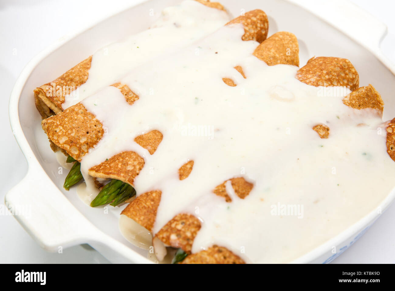 Quinoa crepes preparation : Quinoa crepes with white sauce Stock Photo ...