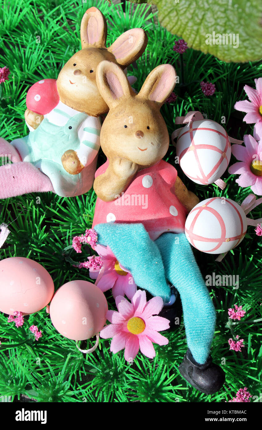 two easter bunnies with easter eggs on a flower meadow Stock Photo - Alamy