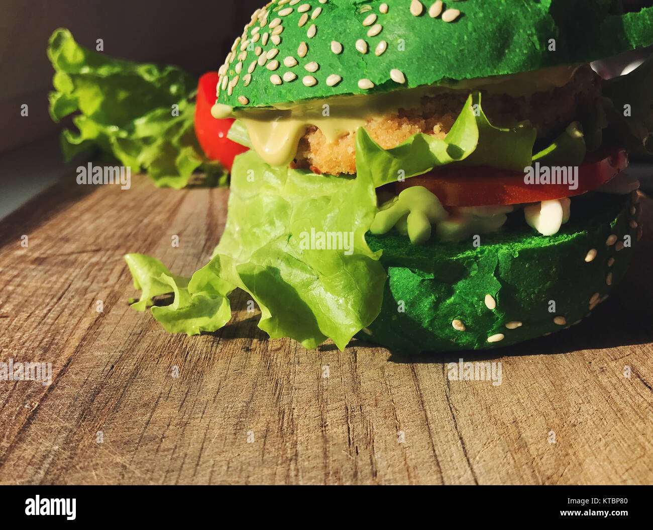 Exotic green burger in bun with sesame seeds tomato lettuce Stock Photo ...