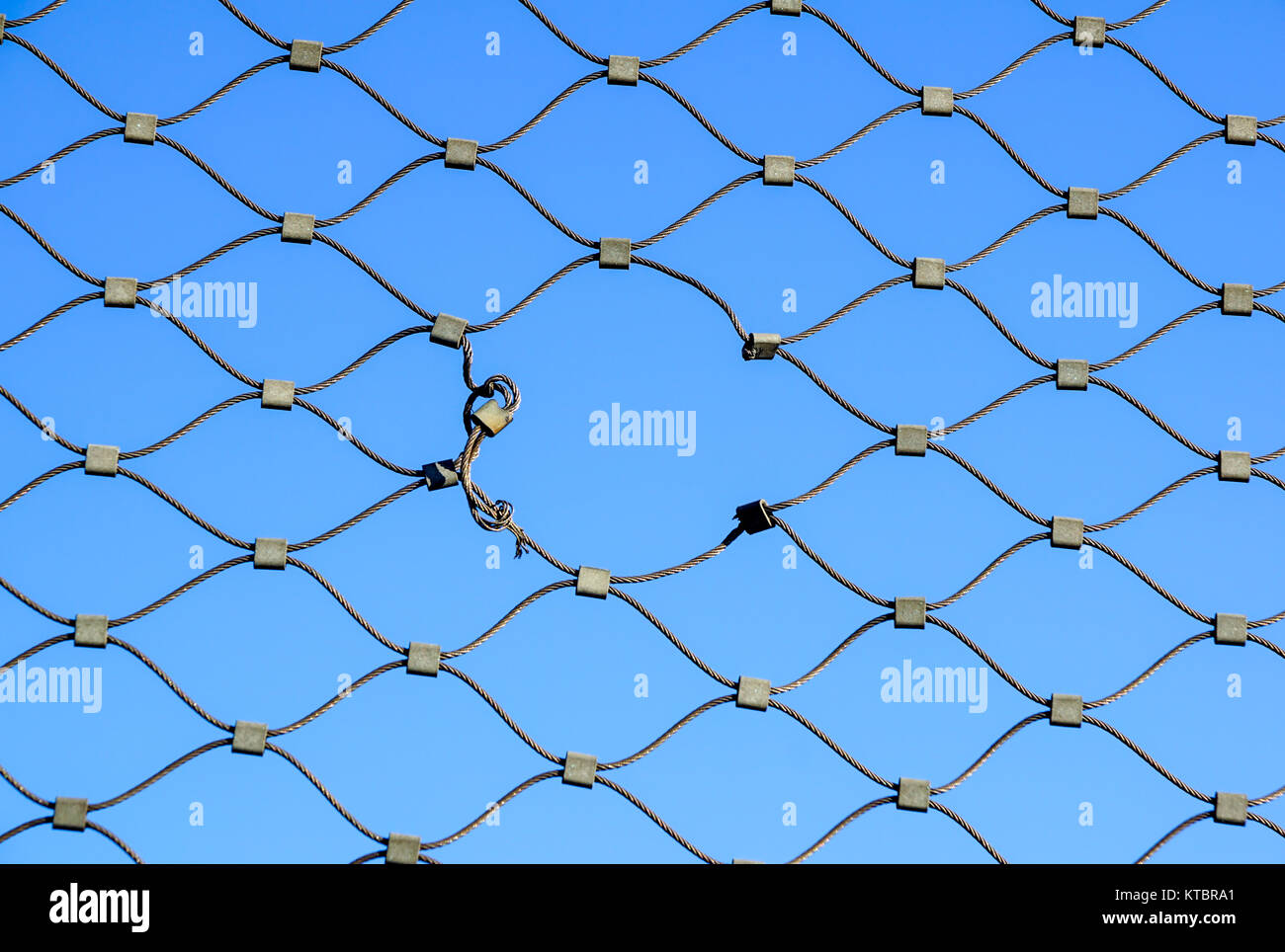 Metal wire fence protection chainlink background . hole Stock Photo - Alamy