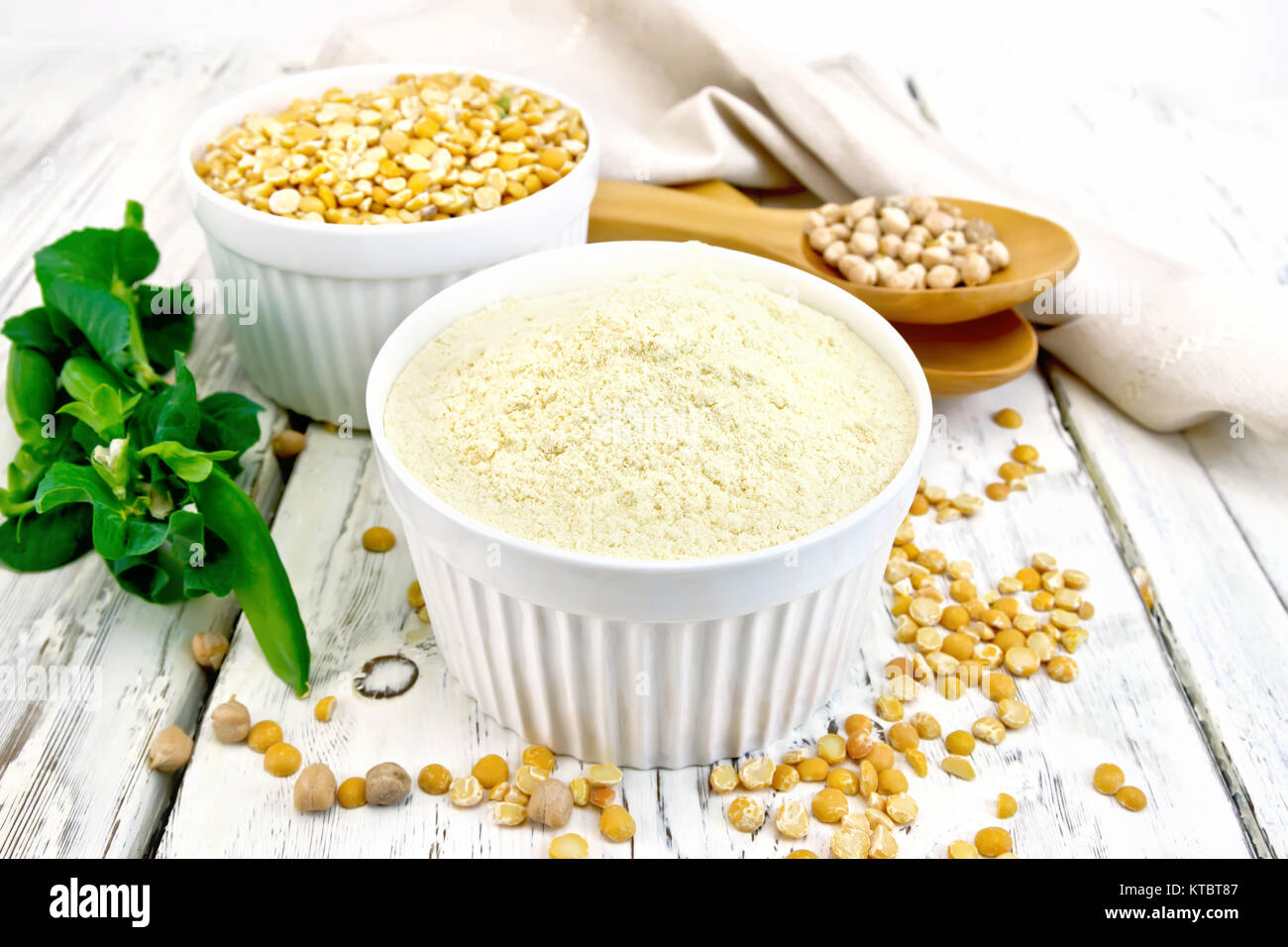 Flour pea and split pease in bowls and spoons on board Stock Photo - Alamy