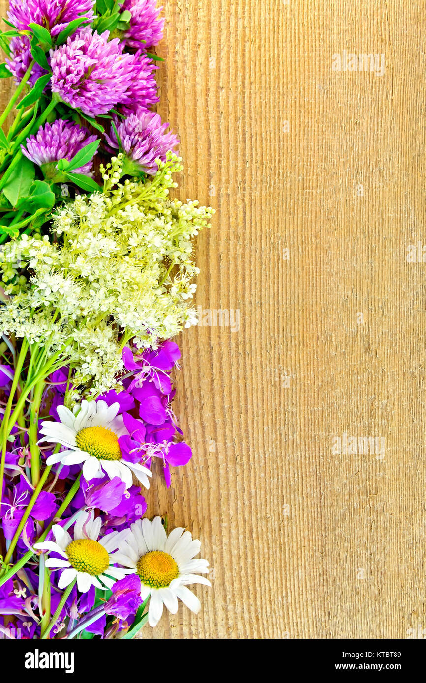Frame of wildflowers on board Stock Photo - Alamy