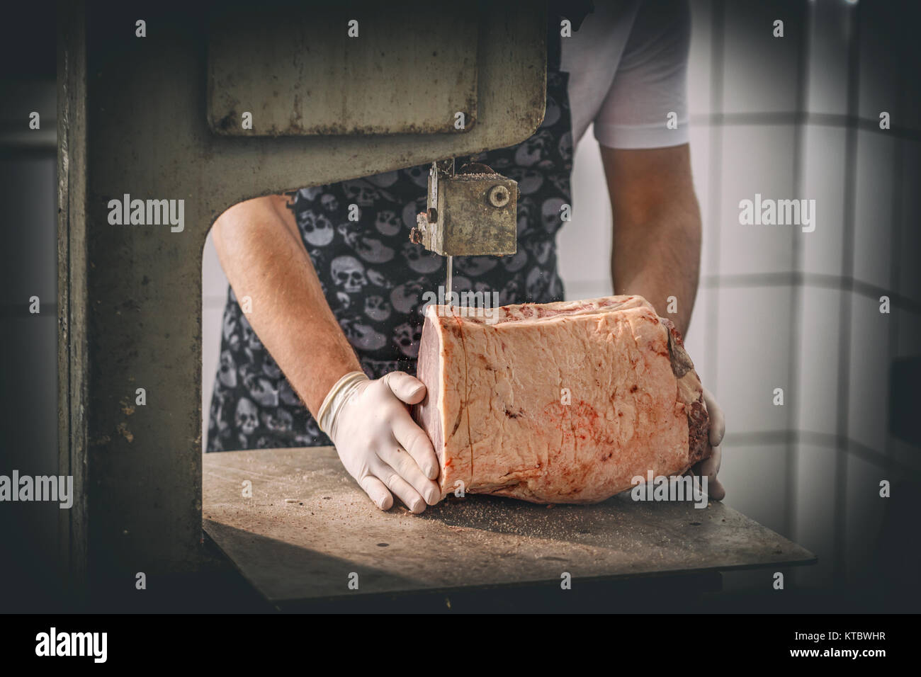 Male butcher's hand slicing meat Stock Photo - Alamy