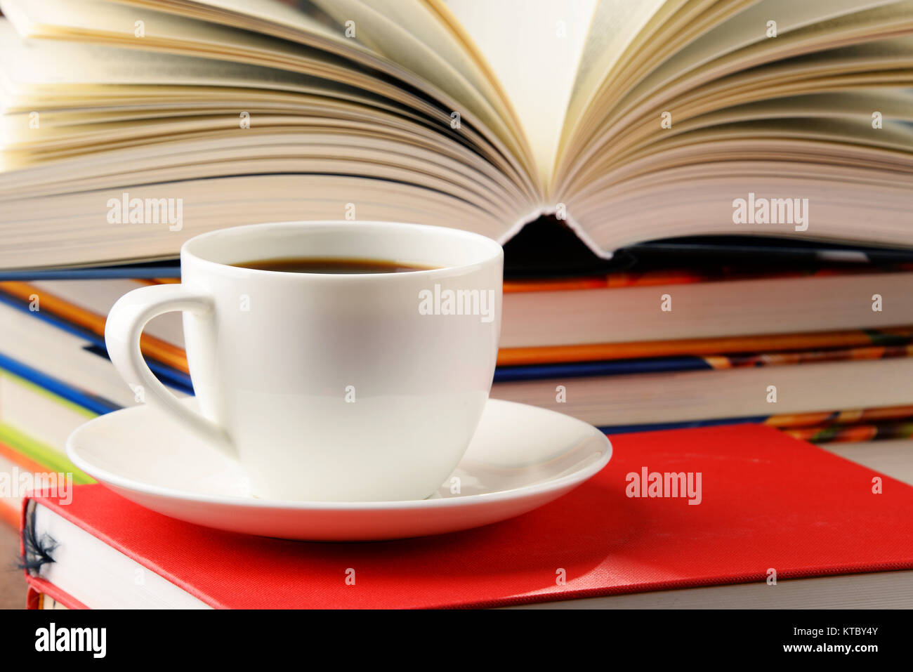 Composition with books and cup of coffee Stock Photo - Alamy