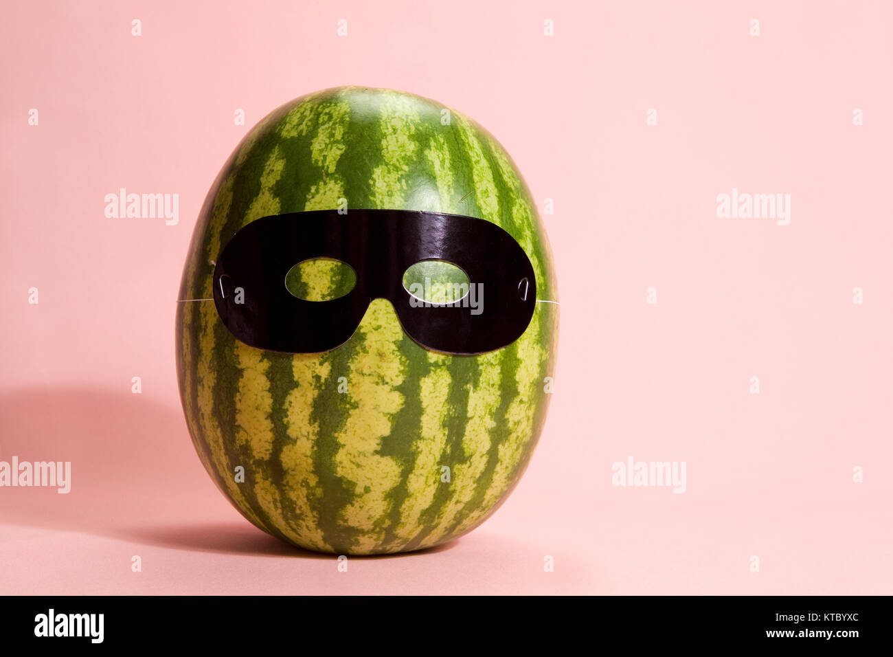 Superwatermelon wearing a black mask Stock Photo - Alamy