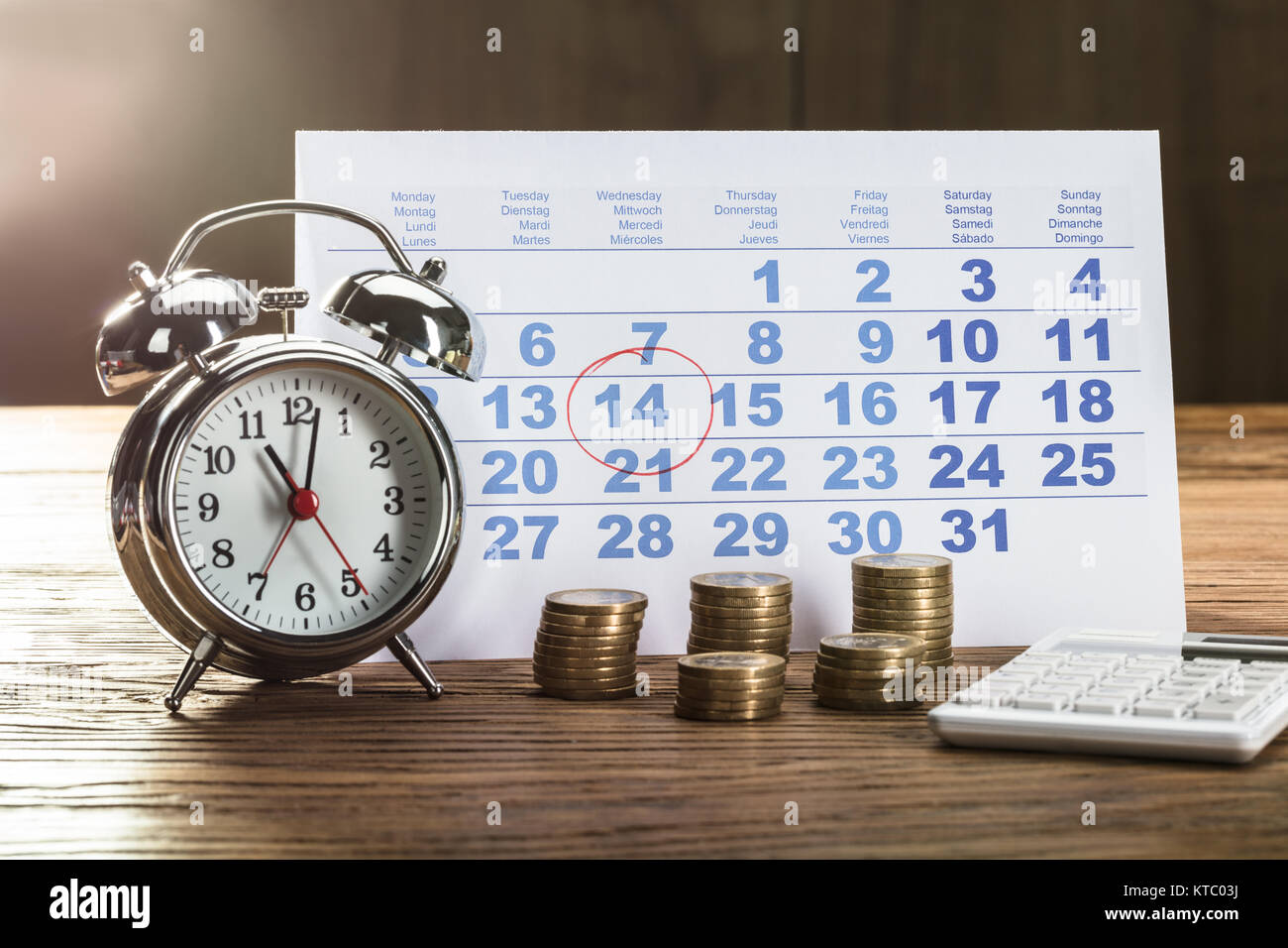 Tax Time On Alarm Clock With Coins Stock Photo - Alamy