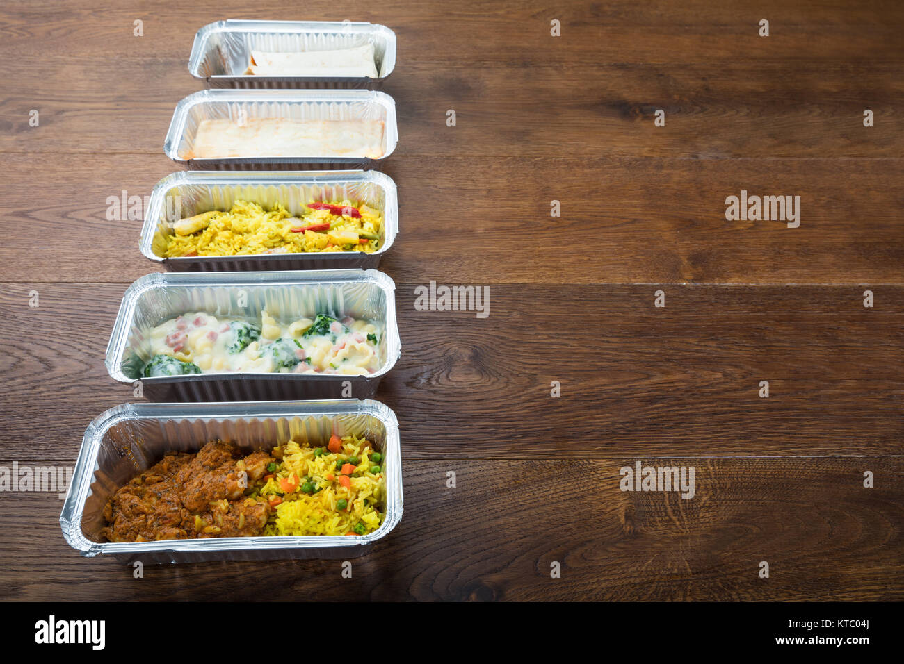Row Of Take Away Dishes On Wooden Table Stock Photo - Alamy