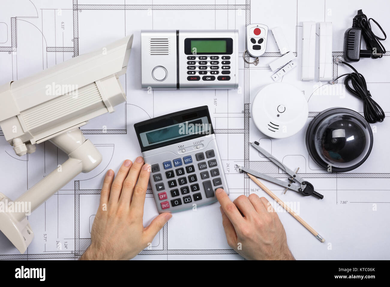Male Engineer Using Calculator With Security Equipments Stock Photo - Alamy