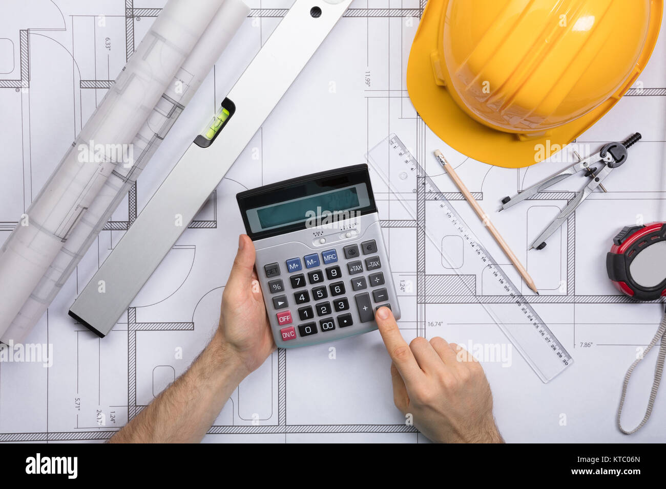 Architect hands using calculator working on blueprint Stock Photo - Alamy