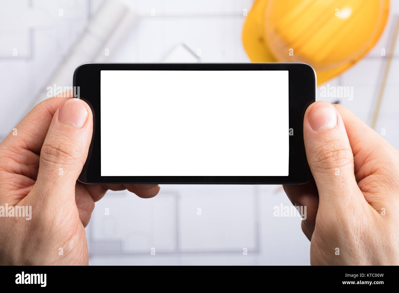 An Engineer Holding Cell Phone Stock Photo - Alamy