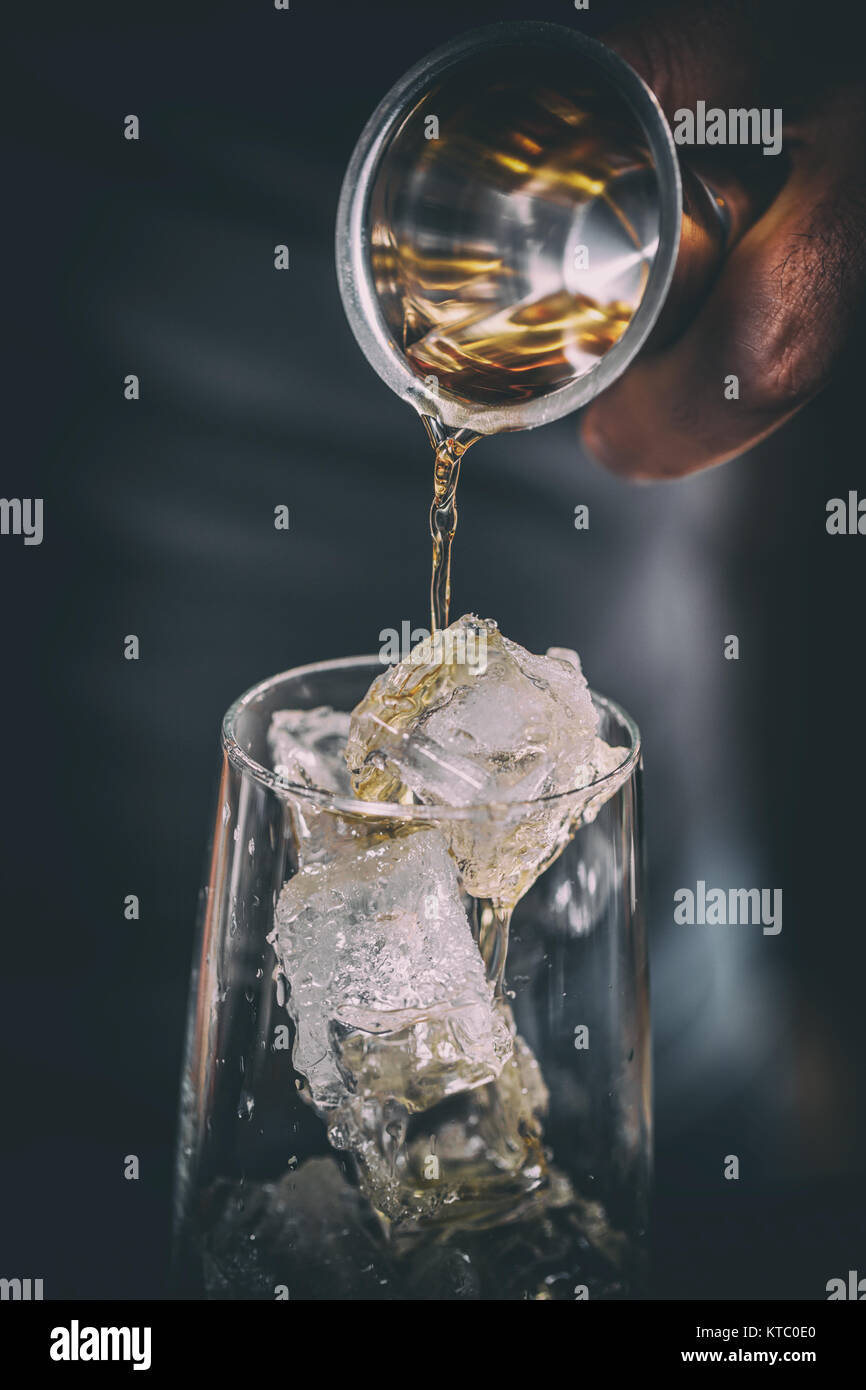 Bartender pouring alcohol Stock Photo - Alamy