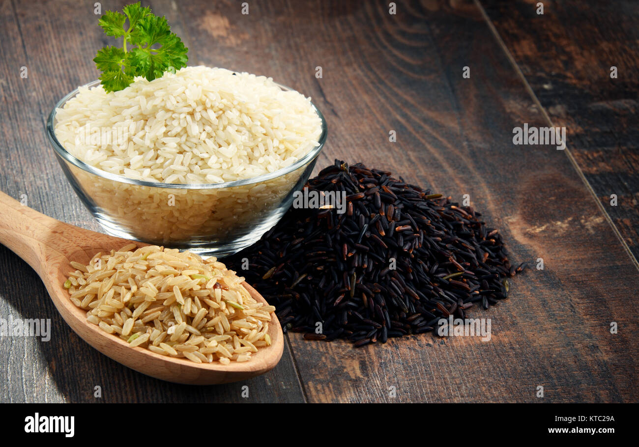 Composition with bowl of rice on wooden table Stock Photo - Alamy